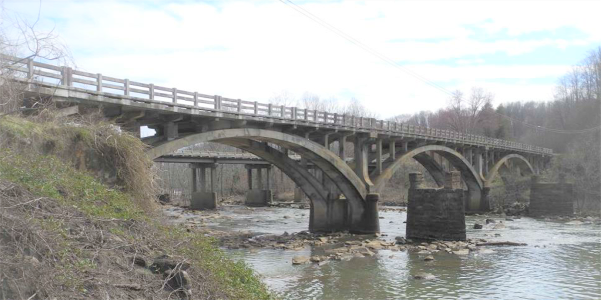 Load Rating of a CIP Open Spandrel Arch Bridge With Curved Widening and ...
